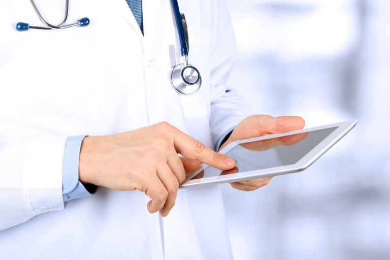 Doctor-with-iPad - Knowledge Capital Group